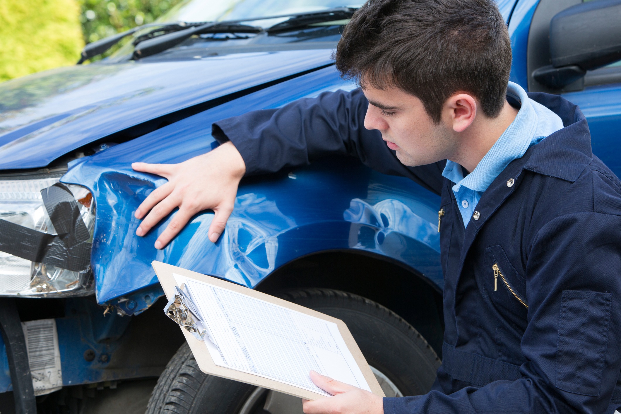 Auto Workshop Mechanic Inspecting Car And Filling In Repair Estimate Auto Body Repair San 